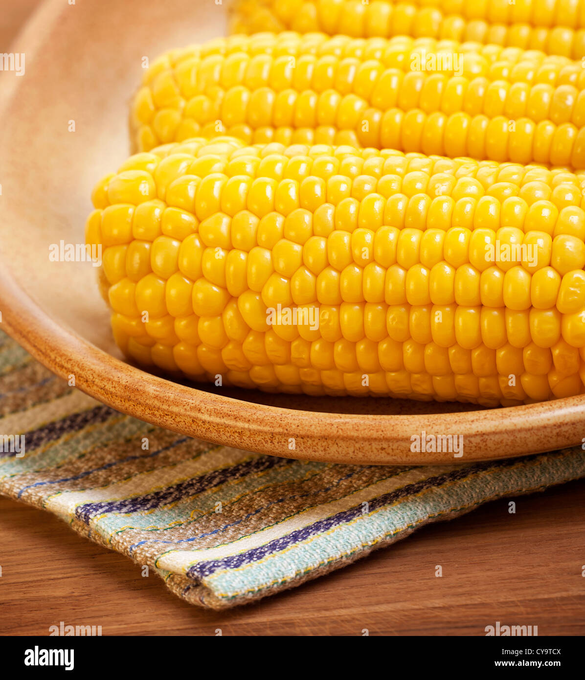 Photo of boiled sweetcorn on the plate in kitchen, tasty healthy cusine ...