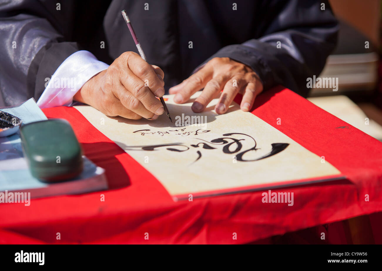 Vietnamese man writing calligraphy Stock Photo - Alamy