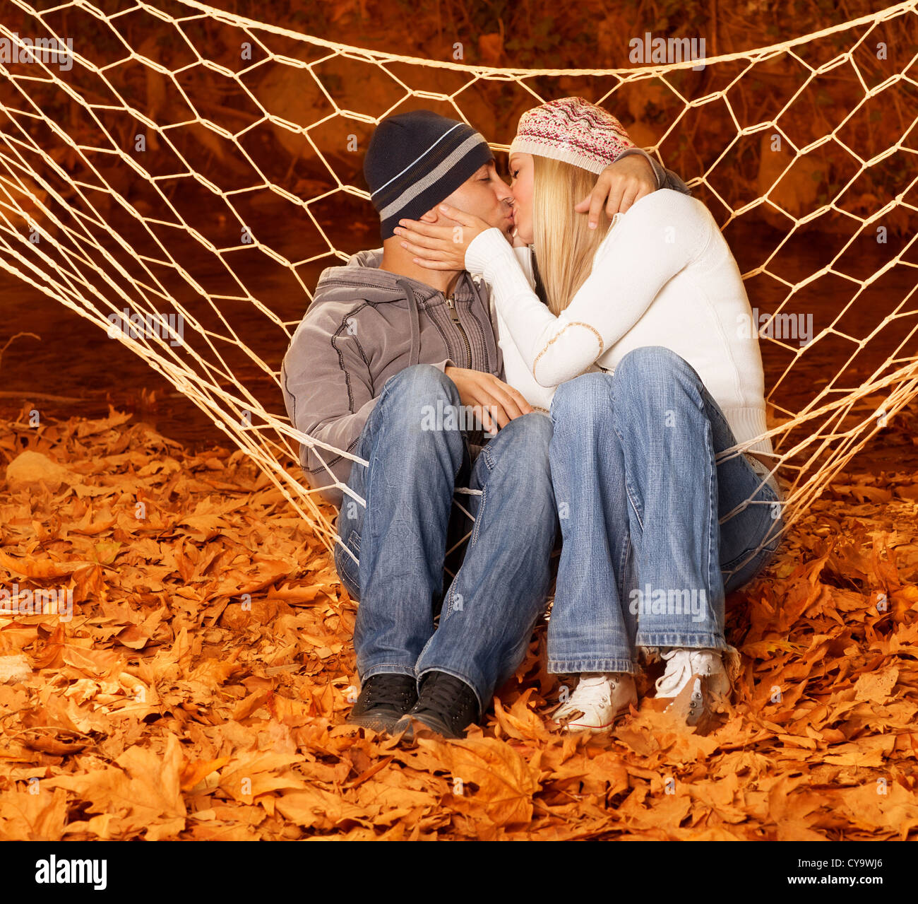 Picture of loving pair swinging in hammock and kissing, romantic ...