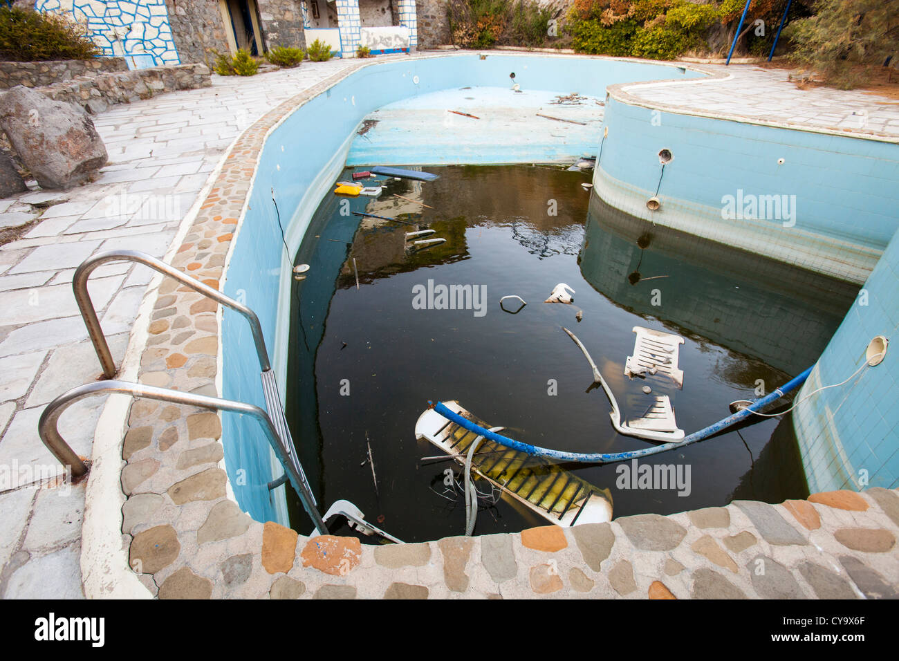 A derelict swimming pool in an abandoned holiday complex in Myrina, on ...
