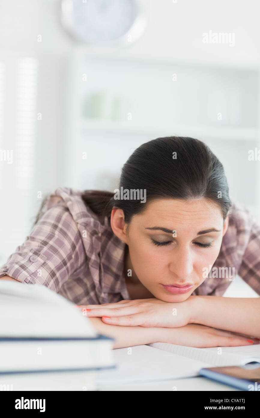 Woman with closed eyes leaning on a table Stock Photo - Alamy