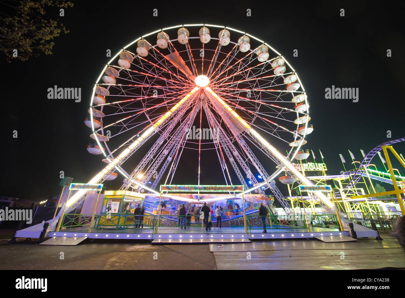 A ferris wheel in the evening at an amusement park Stock Photo - Alamy