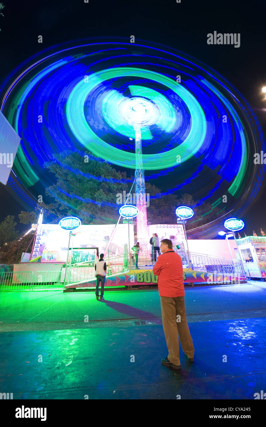 A turning ferris wheel in the evening on an amusement park Stock Photo ...