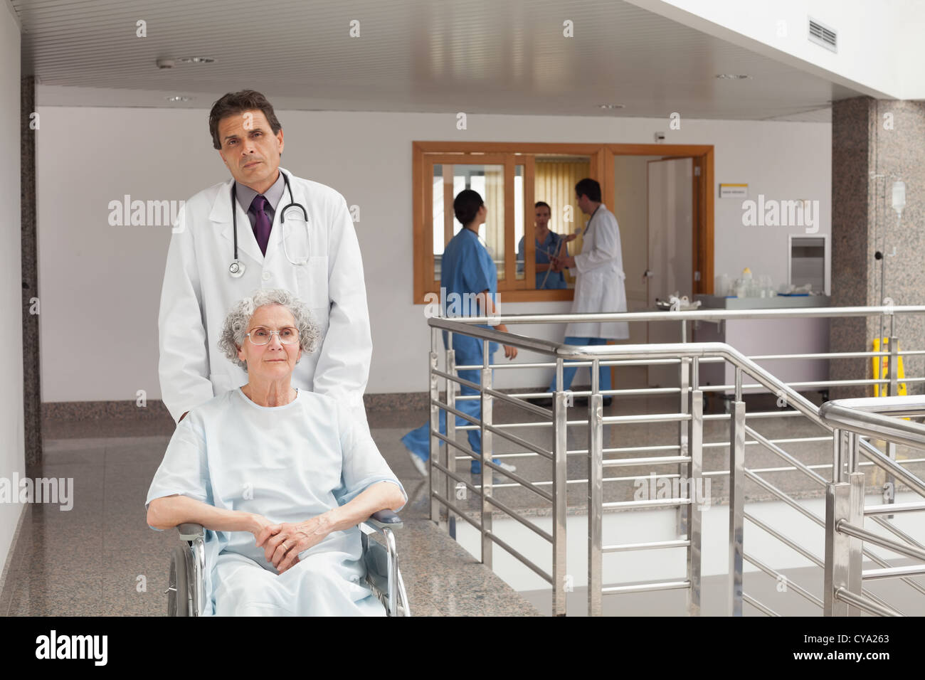 Doctor pushing a woman Stock Photo - Alamy
