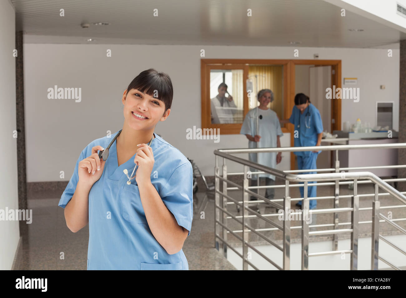 Laughing doctor standing in the hallway Stock Photo - Alamy
