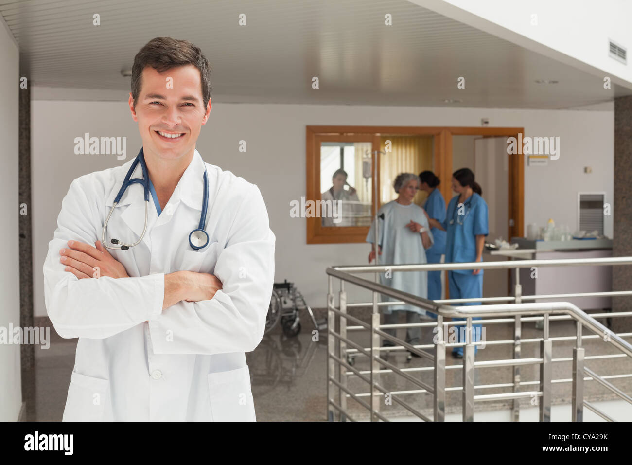 Laughing doctor standing in the hall Stock Photo - Alamy