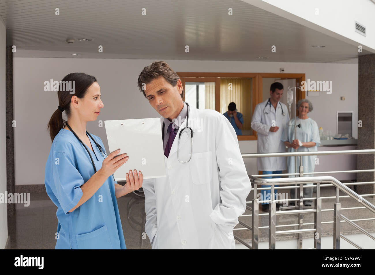 Two doctors standing in the hall Stock Photo - Alamy