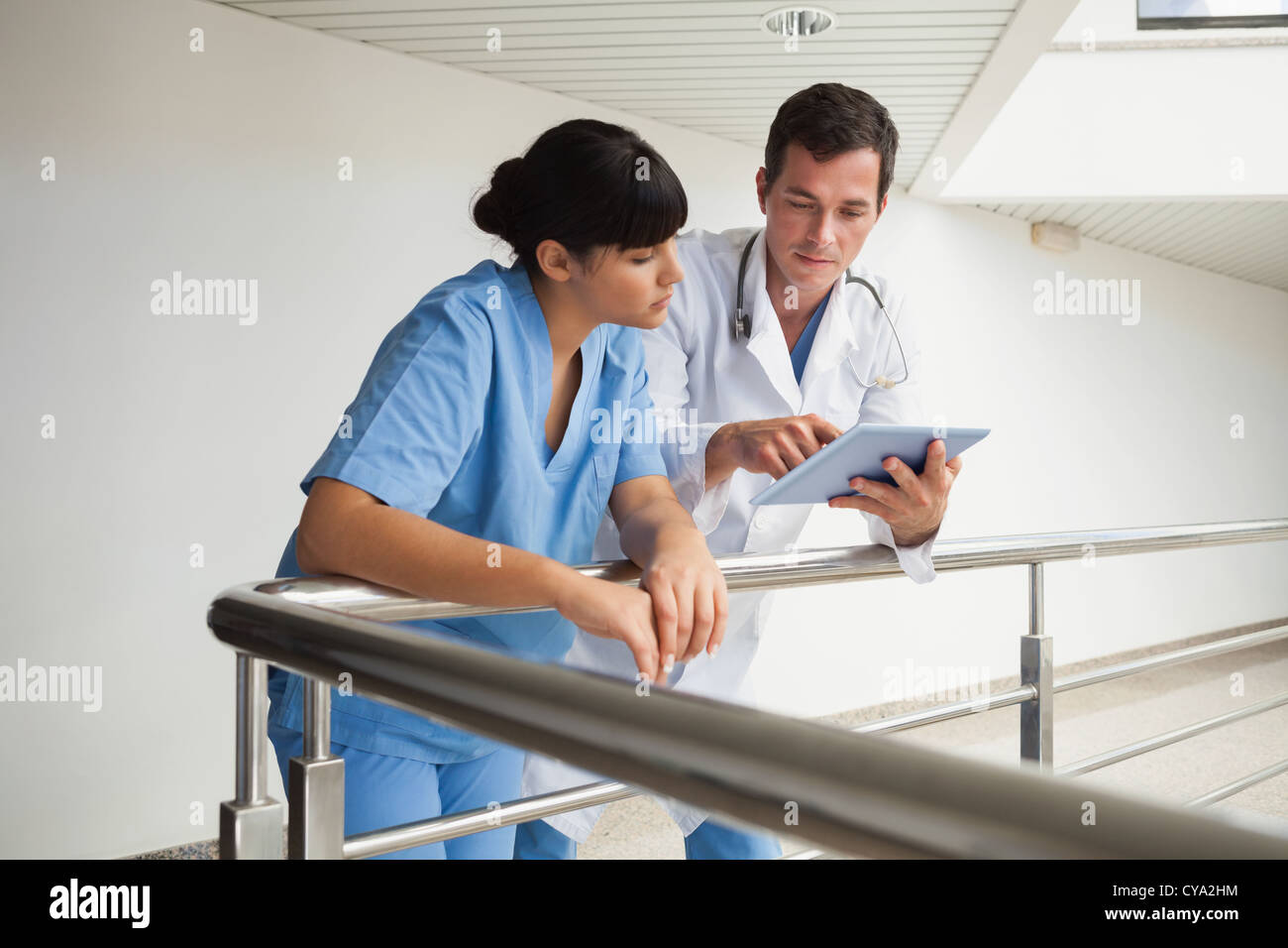 Doctor explaining some exercises to a nurse Stock Photo - Alamy