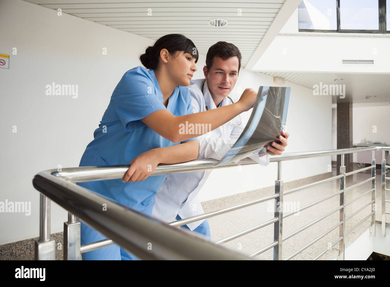 Pointing nurse leaning doctor hi-res stock photography and images - Alamy