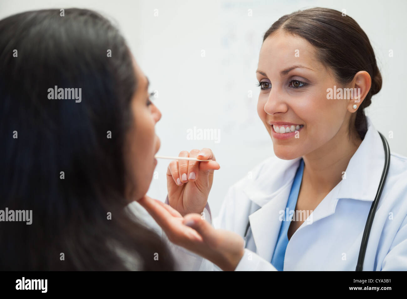 Womans mouth being examined by happy doctor Stock Photo - Alamy