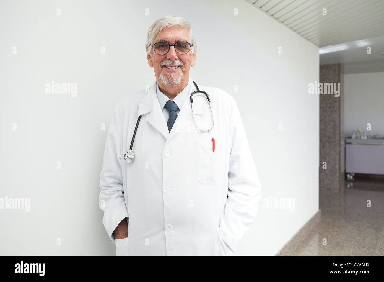 Happy doctor in corridor Stock Photo - Alamy