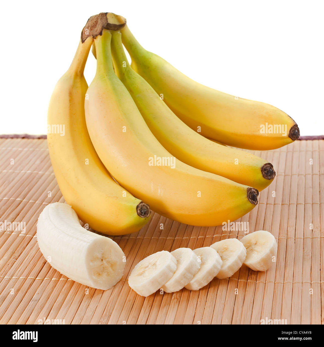 bunch of bananas and slices on a wooden set Stock Photo - Alamy