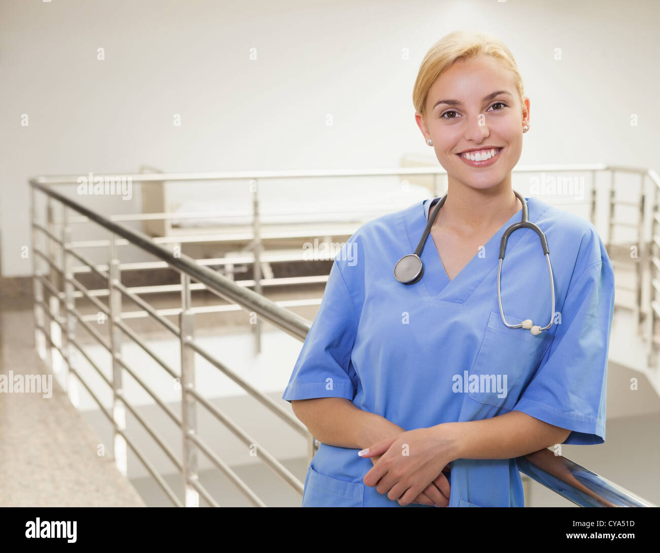 Smiling nurse standing in a stairwell Stock Photo - Alamy