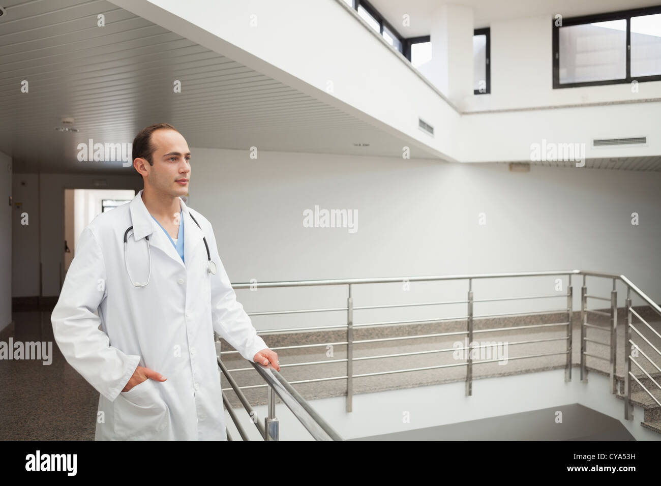 Doctor on stairwell looking ahead Stock Photo - Alamy