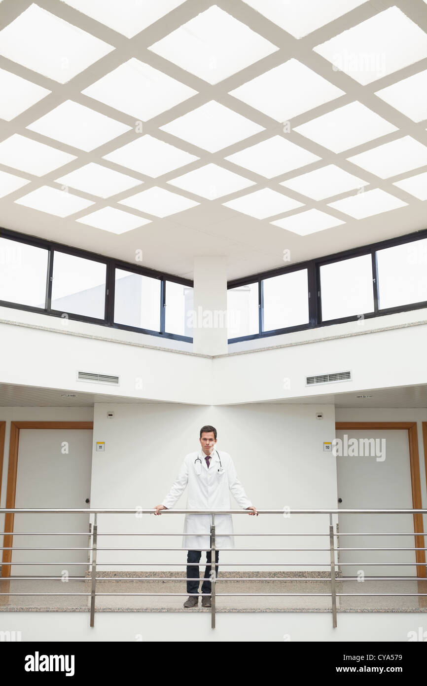 Doctor standing in stairwell Stock Photo - Alamy
