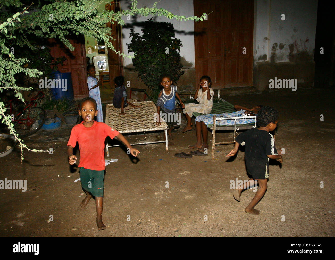 Kids Playing In Front Of Their House At Night, Massawa, Eritrea Stock Photo - Alamy