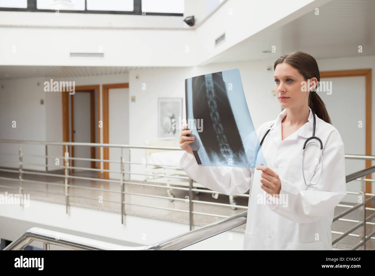 Female doctor analysing x-ray at stairwell Stock Photo - Alamy