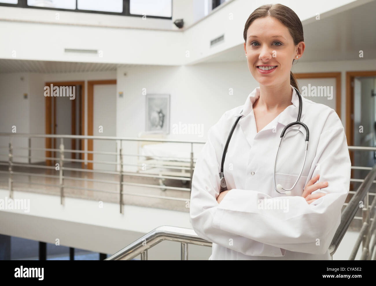 Female smiling doctor standing at the stairwell Stock Photo - Alamy