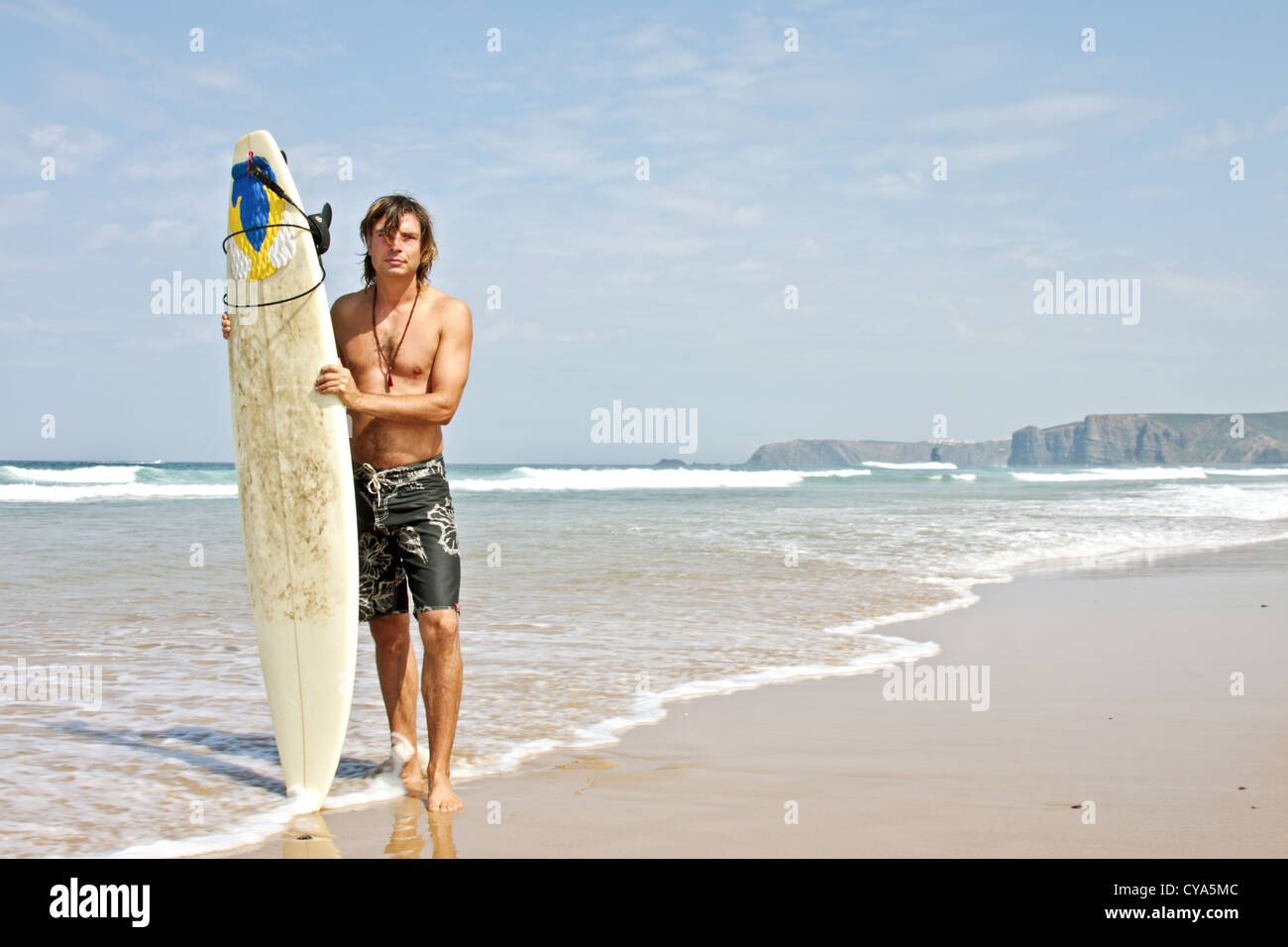 Surfer and his surfboard at the beach ready to surf on the atlantic ...