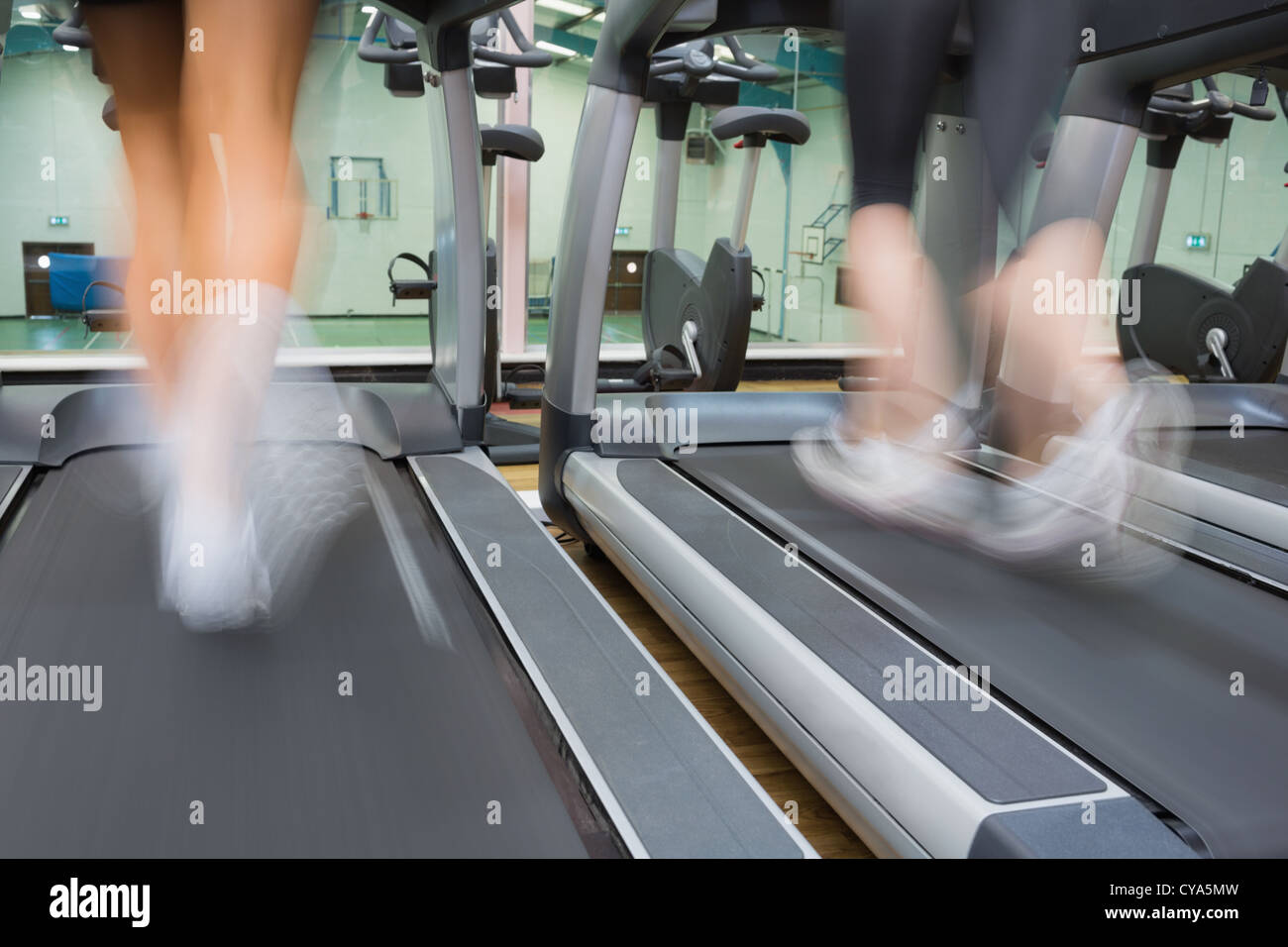 Two people running on treadmills Stock Photo - Alamy