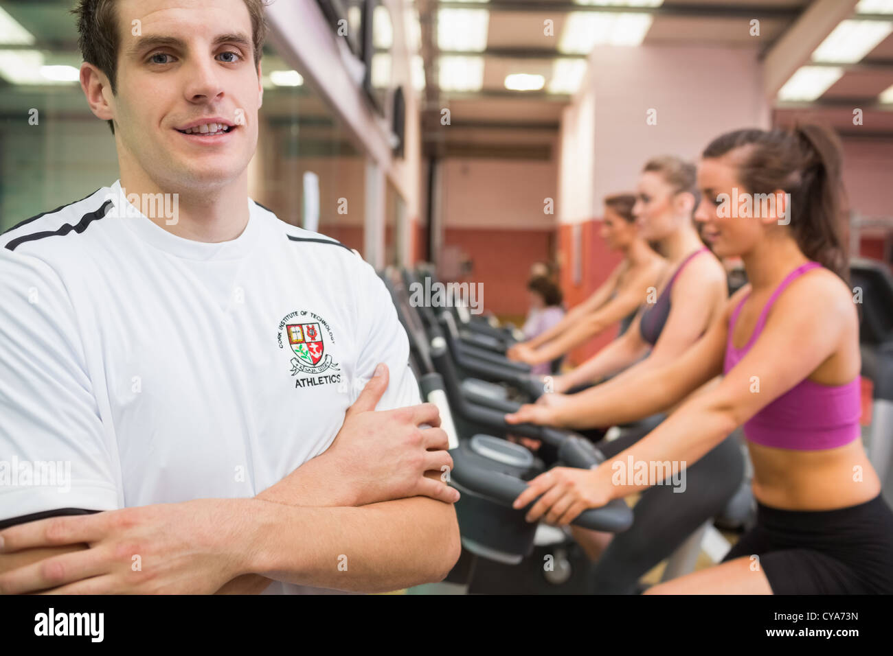 Man with arms crossed in gym Stock Photo - Alamy