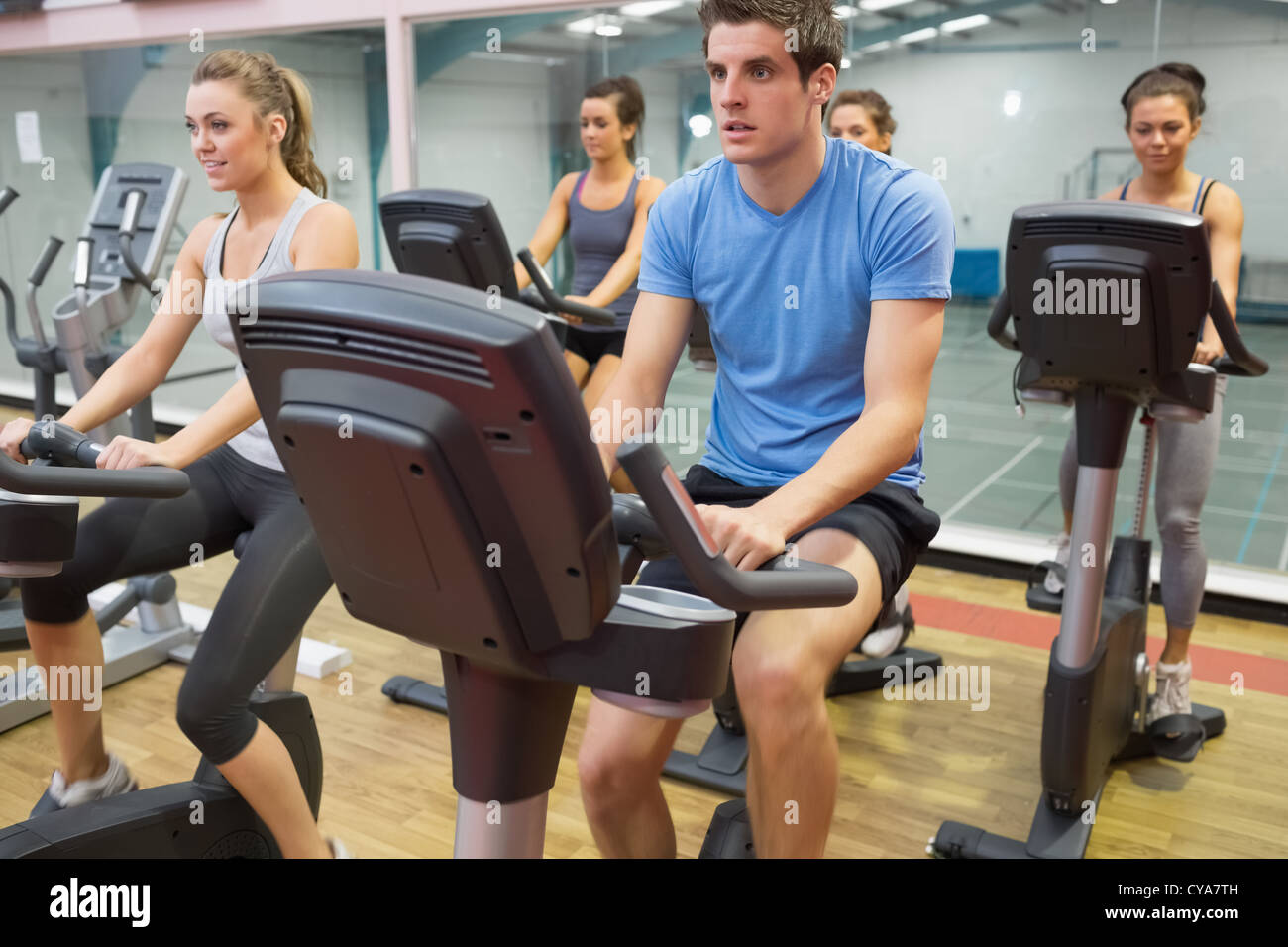 Spinning class riding on an exercise bikes Stock Photo - Alamy
