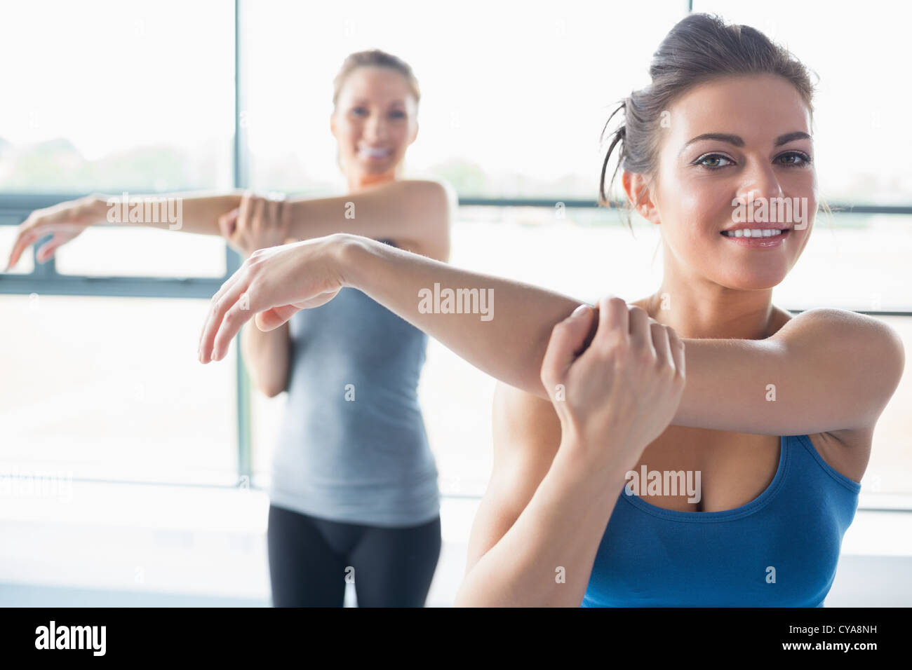 Two women stretching their arms Stock Photo - Alamy