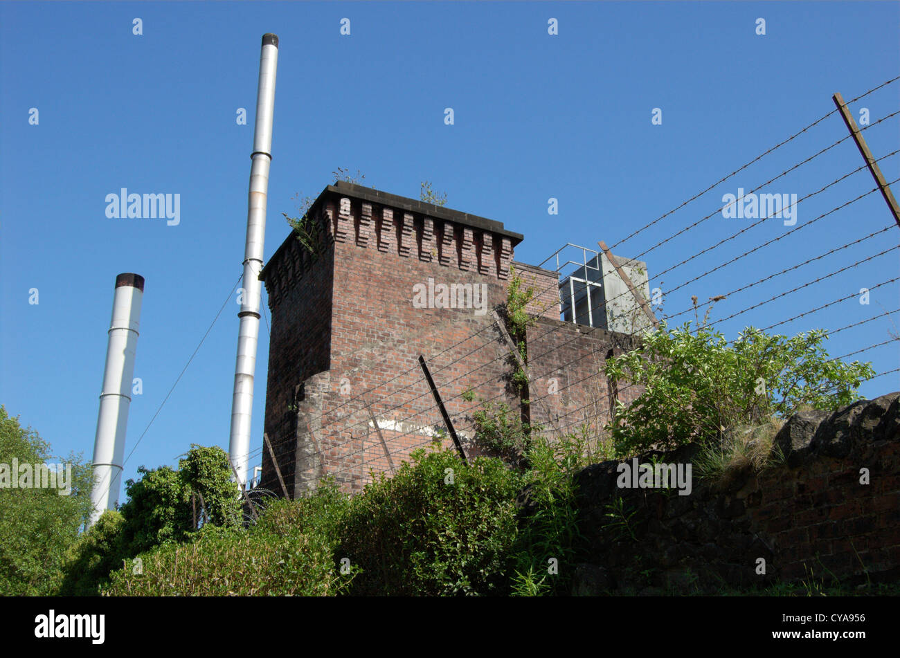 Brewery chimneys against a clear blue sky Stock Photo - Alamy