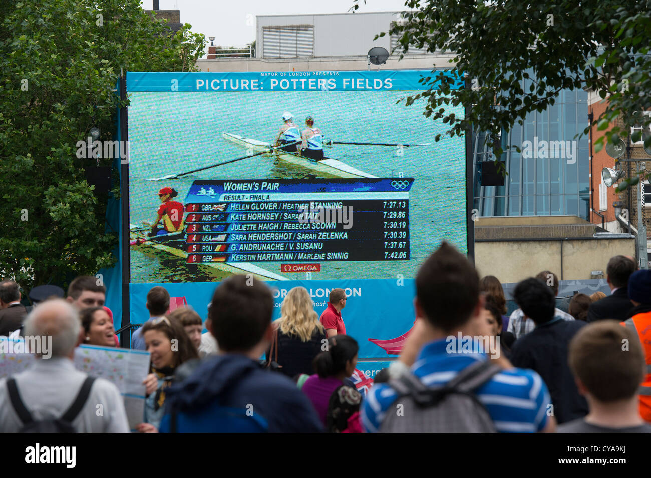 Spectators watching the rowing event on a screen during the London 2012 ...