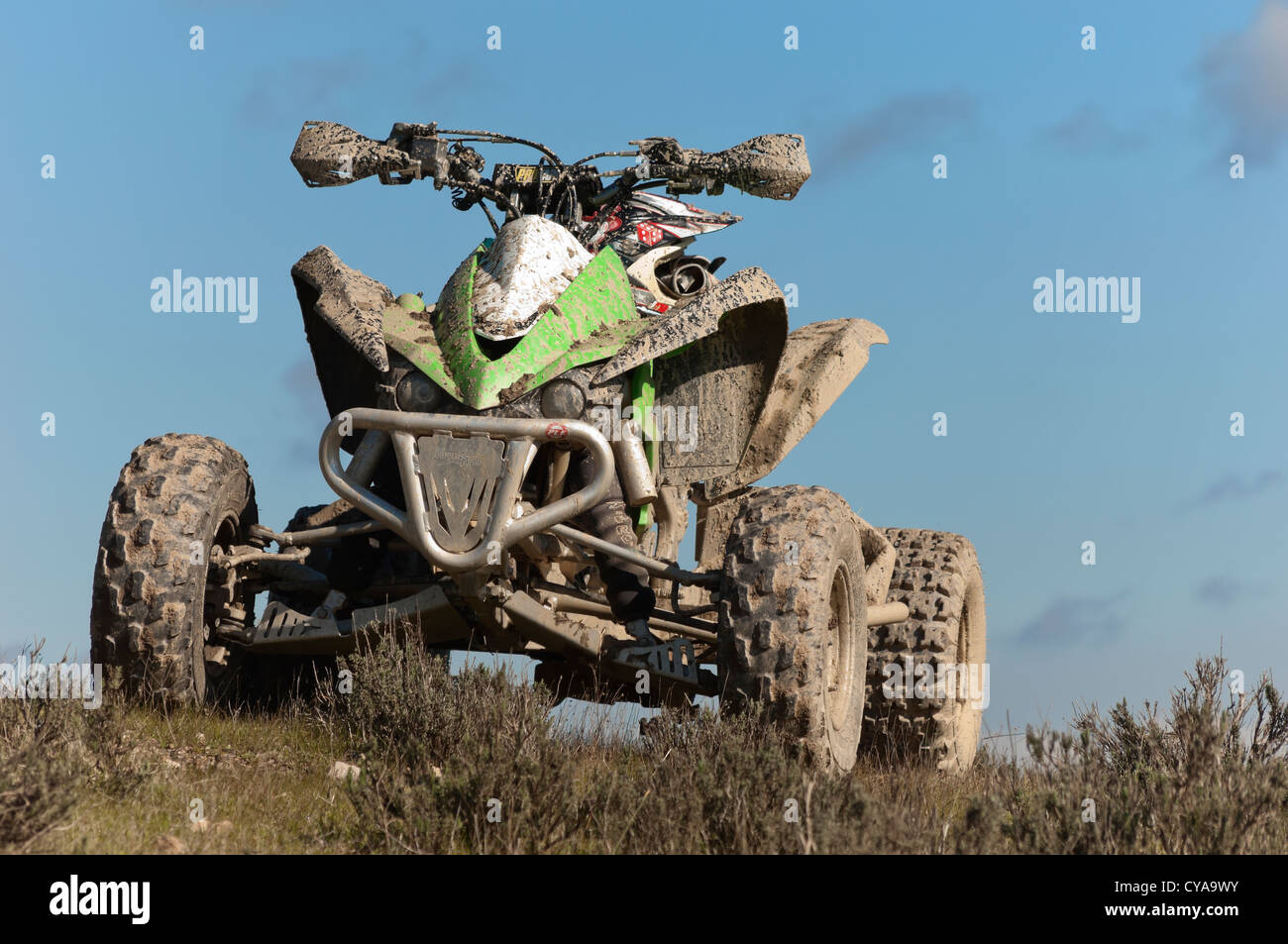 Muddy quad bike view from below left alone on a hill Stock Photo - Alamy