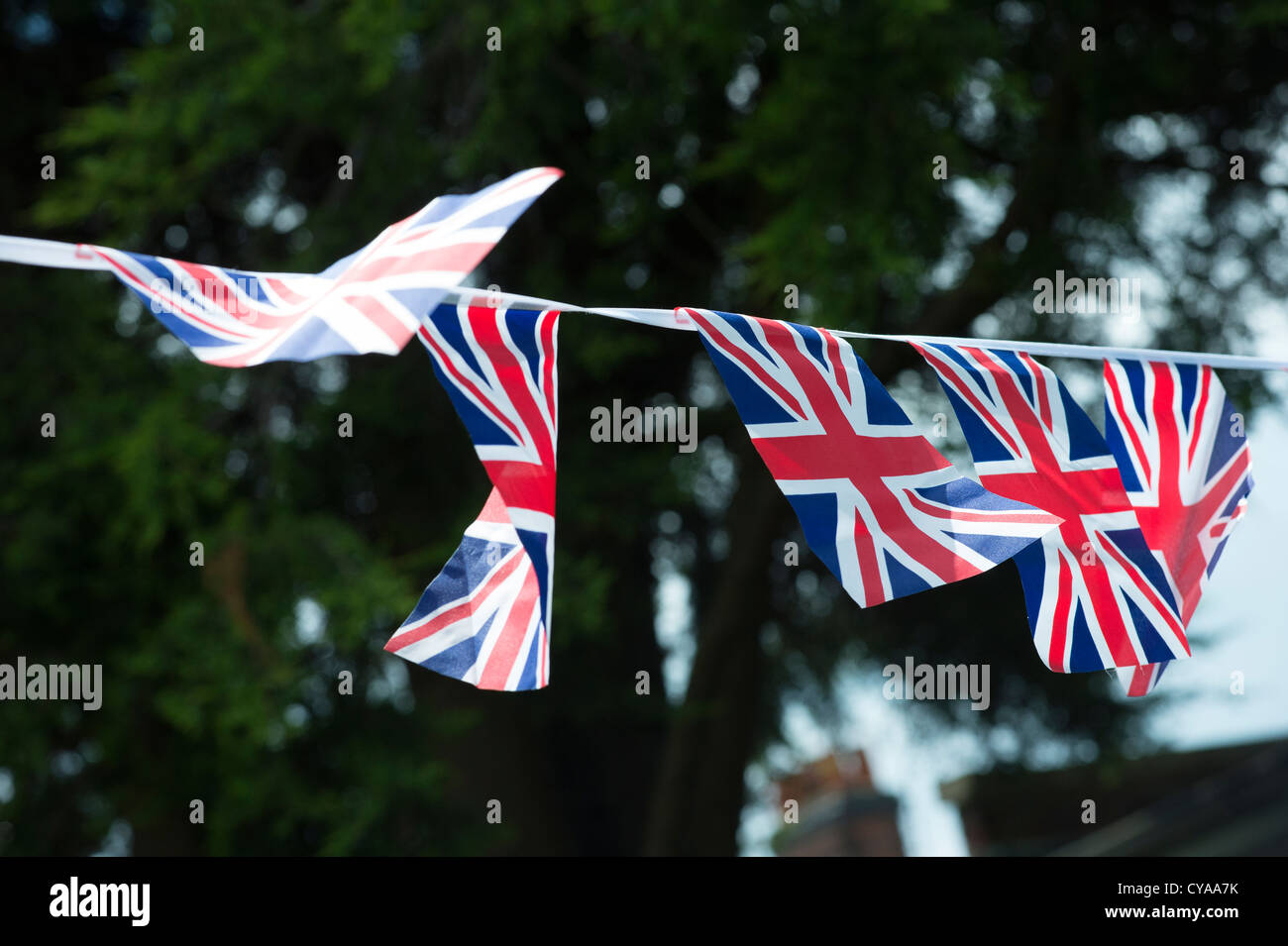 Union jack bunting fluttering in the breeze Stock Photo - Alamy