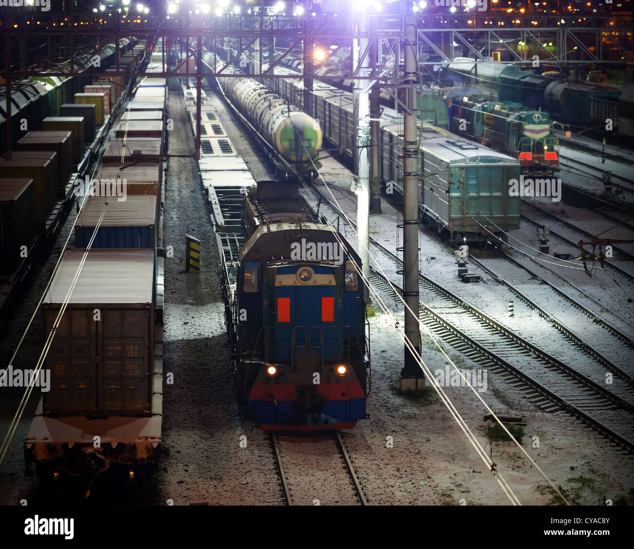 Railroad night scene with lights and cargo trains Stock Photo - Alamy