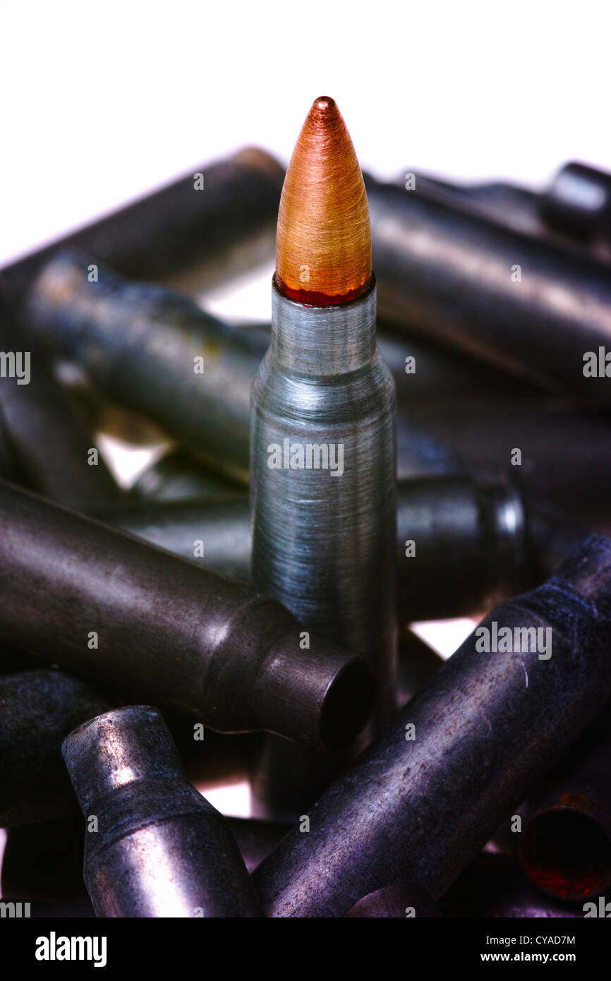 Brand new bullet into of used empty old bullet cartridges Stock Photo ...