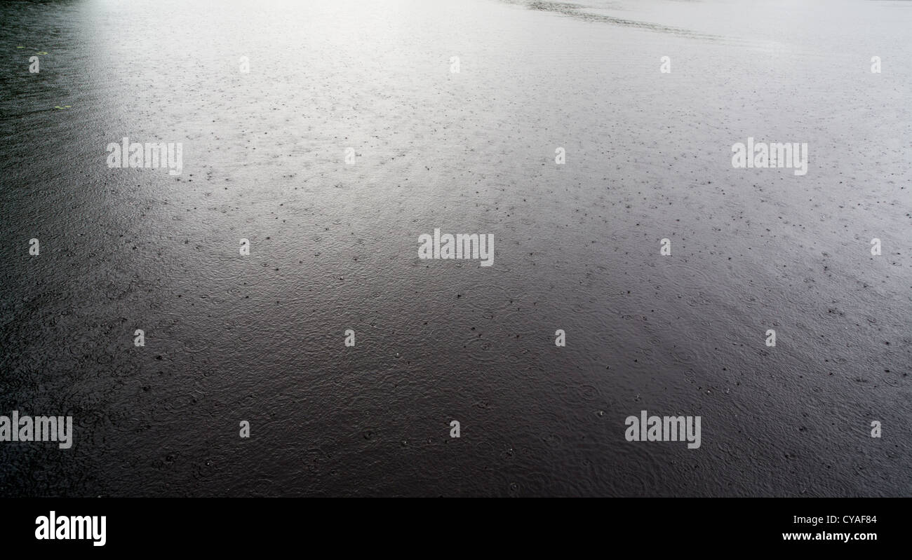Raindrops on water surface Stock Photo - Alamy