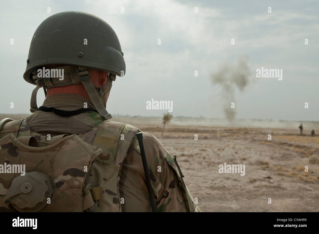 A coalition force member watches a controlled detonation during an ...