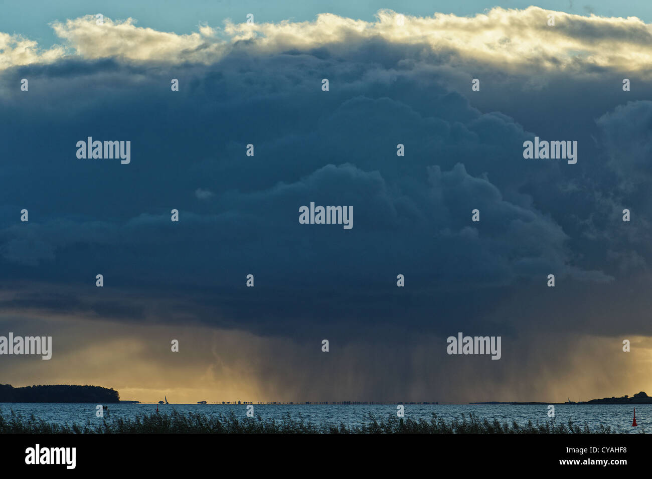 Large cloud with a rain shower beneath Stock Photo - Alamy