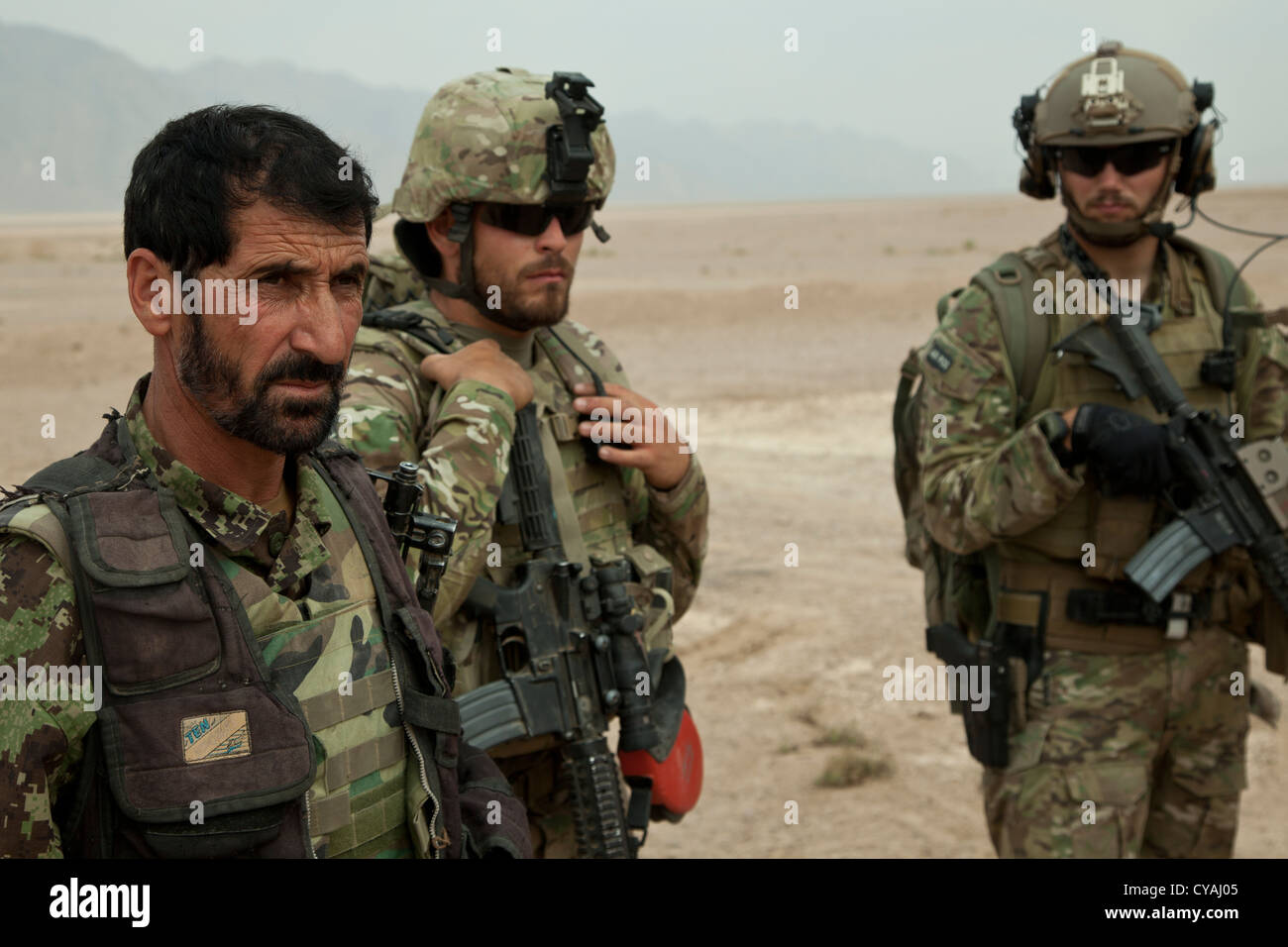 Coalition force members wait for an Afghan National Army commander to ...