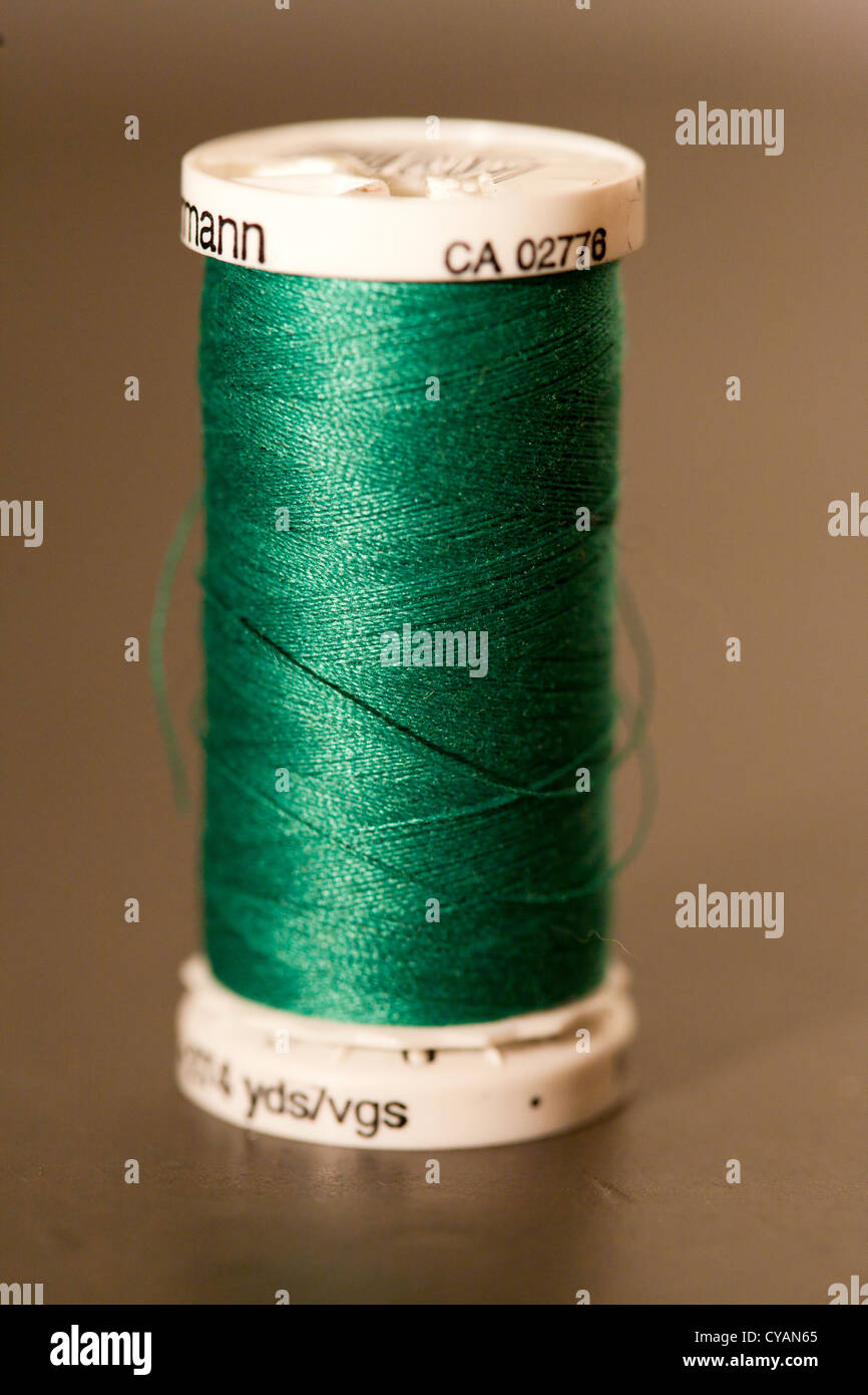 Spool of green thread Stock Photo - Alamy