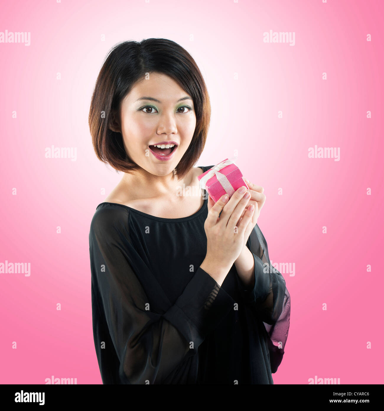 Happy Chinese girl with a gift in her hand Stock Photo - Alamy