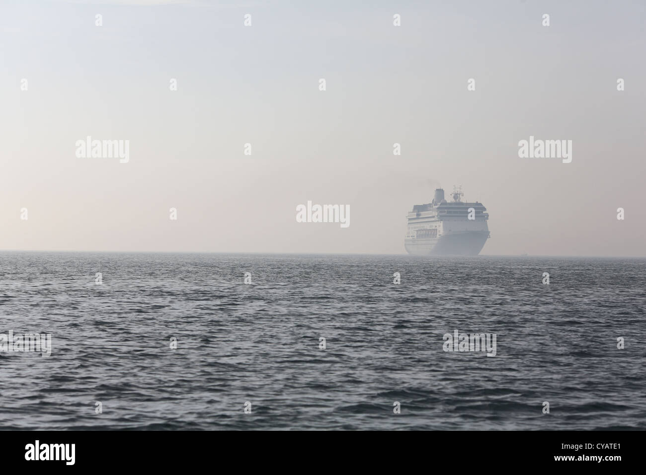 Ferry boat traveling in the distance at sea Stock Photo - Alamy