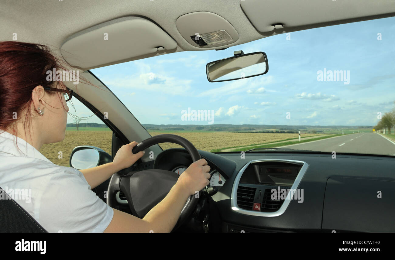 Woman driving on country road hi-res stock photography and images - Alamy