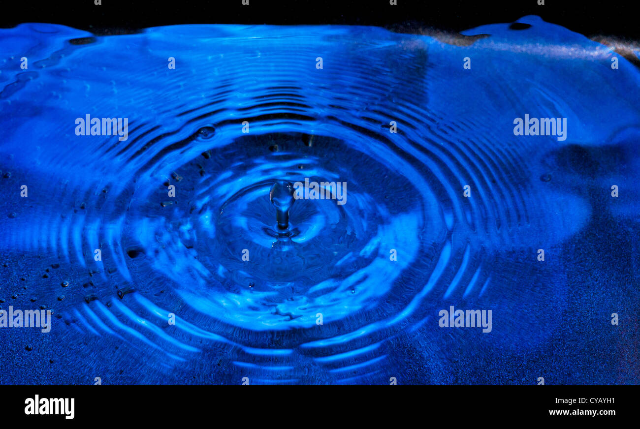 Drop of water that is blue slashes Stock Photo - Alamy