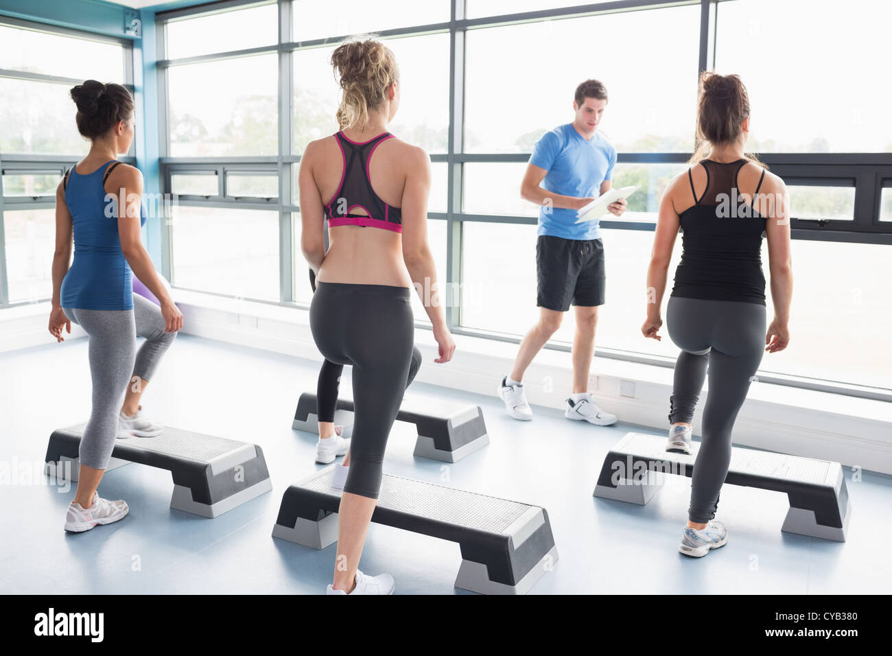 Trainer teaching his aerobics class Stock Photo - Alamy