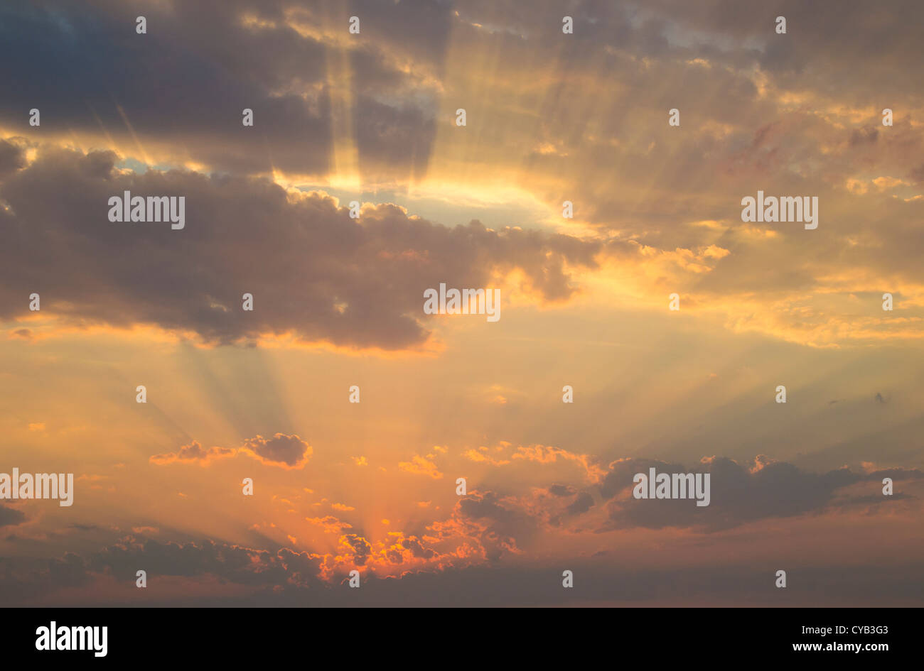 Heavenly rays of sunlight through a cloudscape above horizon of the ...