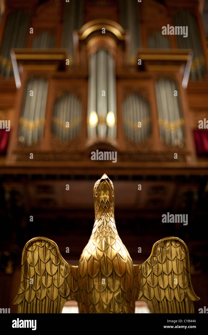 Golden eagle on a globe with a church organ in the background in ...