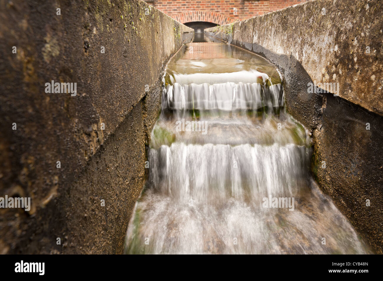 Waterfall and water stream in channel canal cutting flowing over ...