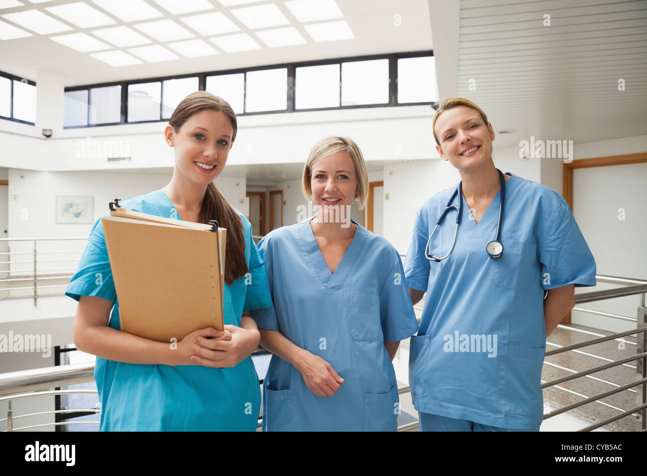 Three nurses in stairwell Stock Photo - Alamy