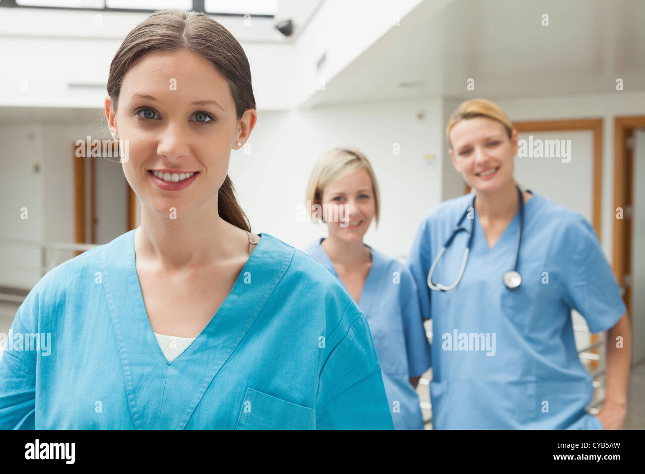 Smiling nurse with two friends Stock Photo - Alamy