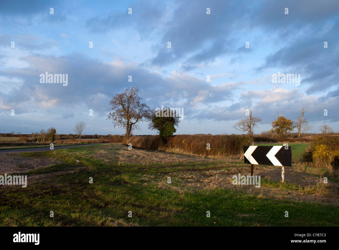 Sharp Deviation Road Sign on wide verge with hedges and trees in the ...