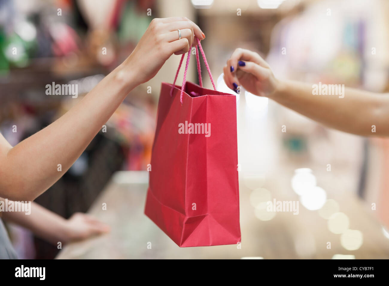 Woman handing over shopping hi-res stock photography and images - Alamy